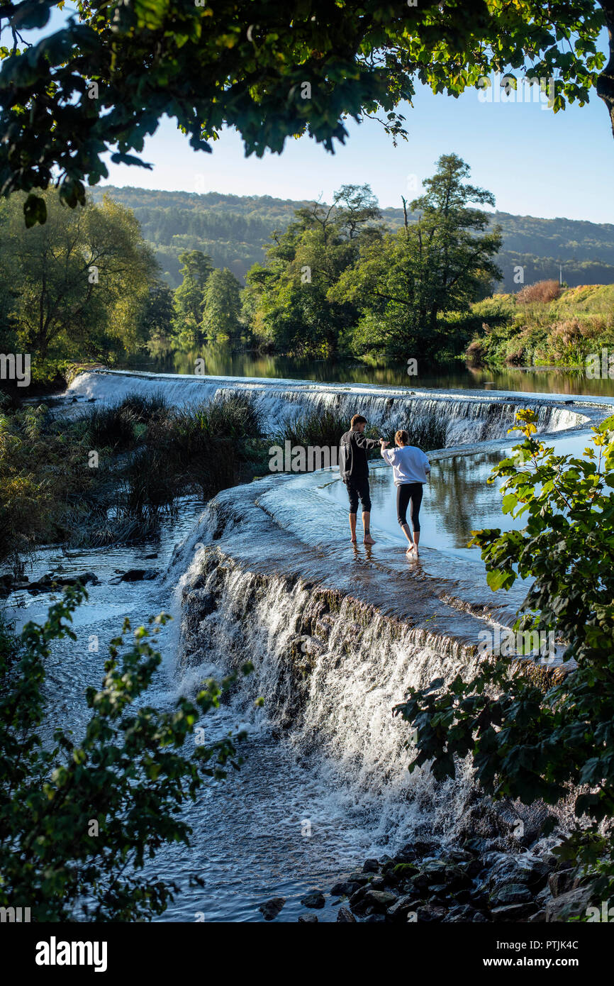 A couple paddle in the river Avon at Warleigh Weir in Somerset as ...