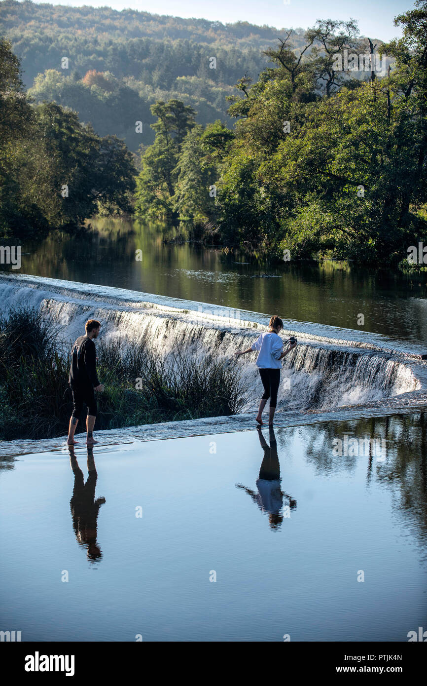 A couple paddle in the river Avon at Warleigh Weir in Somerset as ...
