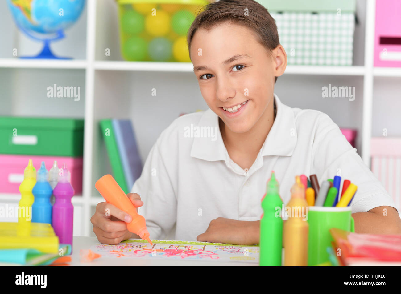 Portrait of a cute teen boy drawing Stock Photo - Alamy