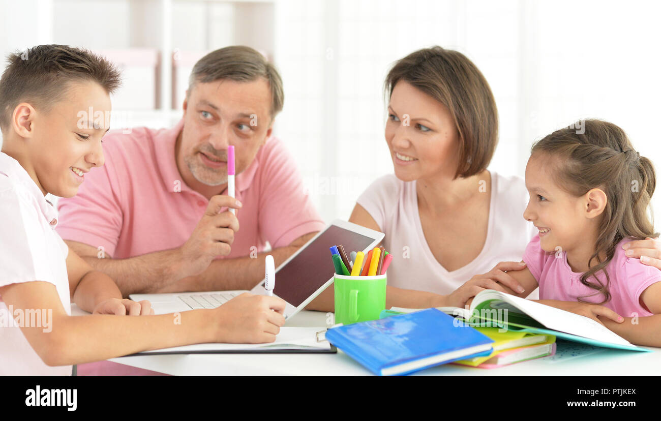 Portrait of big happy family doing homework Stock Photo - Alamy