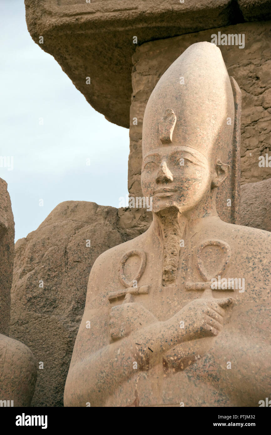 A statue of the pharaoh holding two ankhs, at the Karnak Temple complex ...
