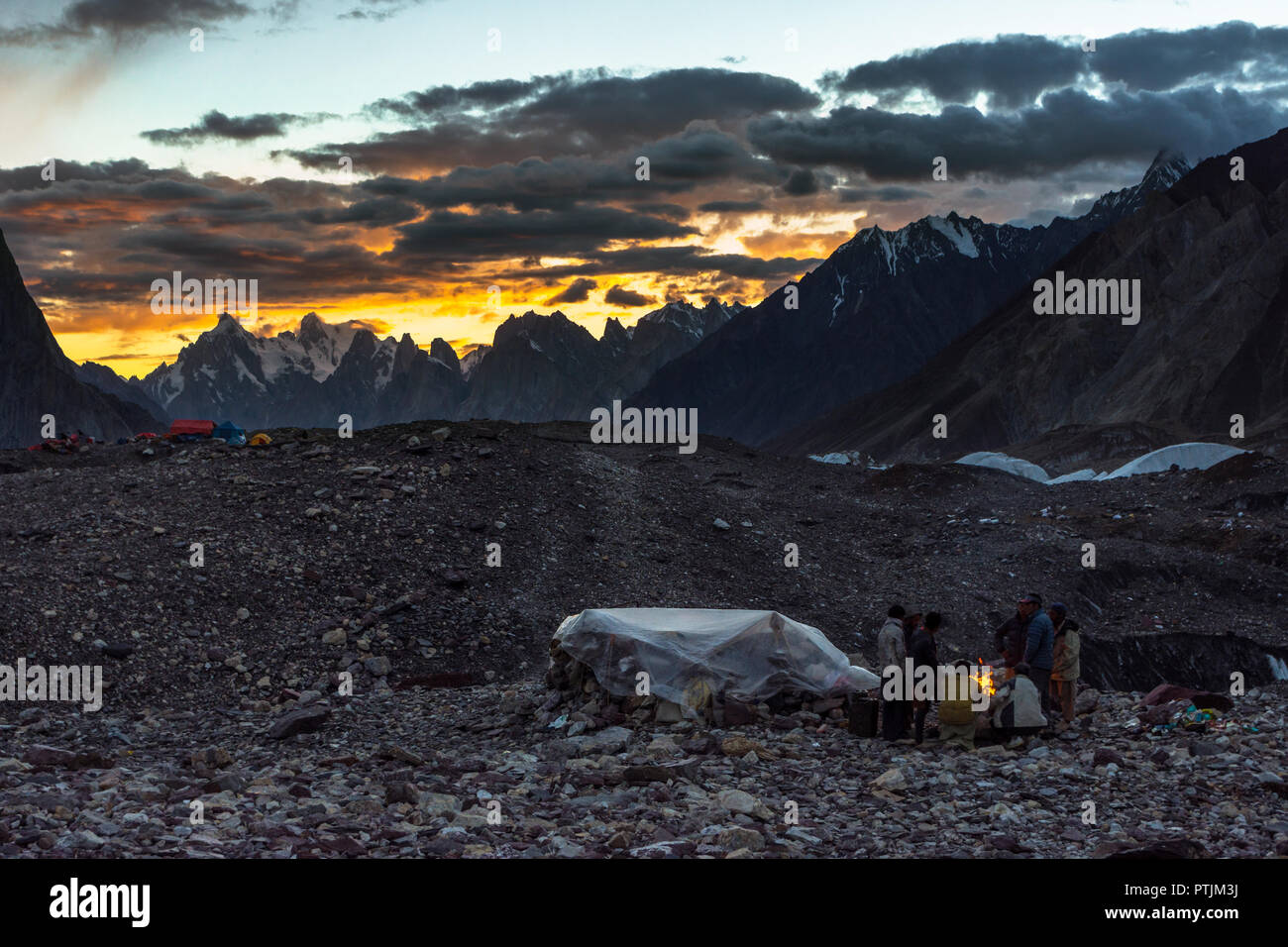 Porters next to campfire in Concordia during sunset, Karakoram ...
