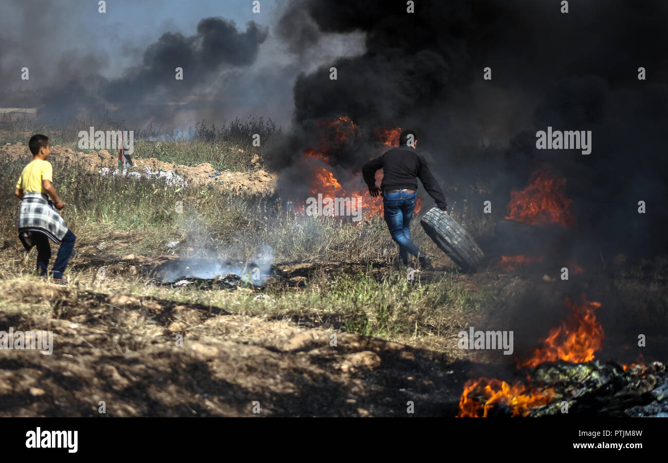 A photo of Palestinian protesters set tires on fire during a ...