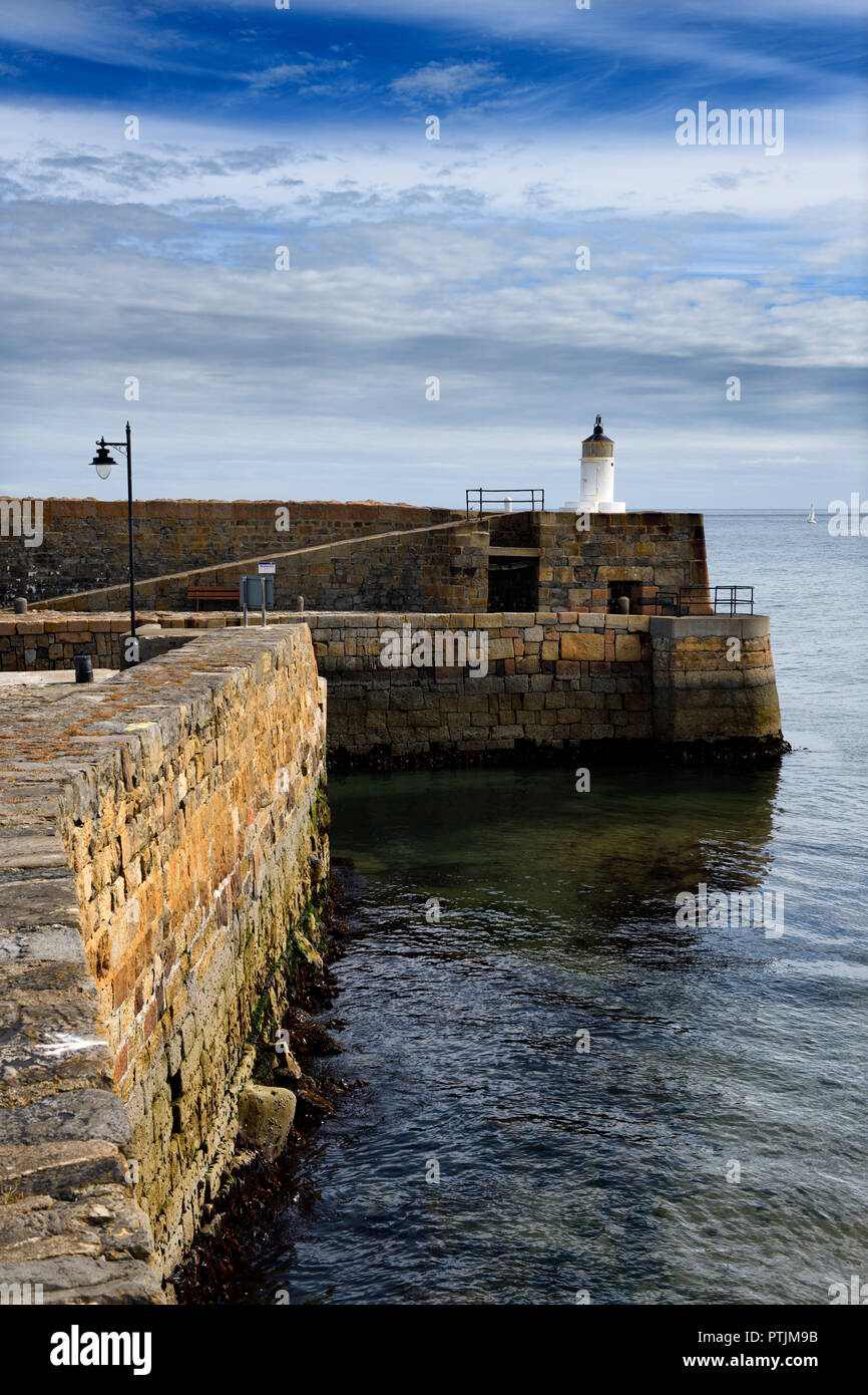 Lighthouse on stone walls of Banff Harbour on Banff Bay Moray Firth ...