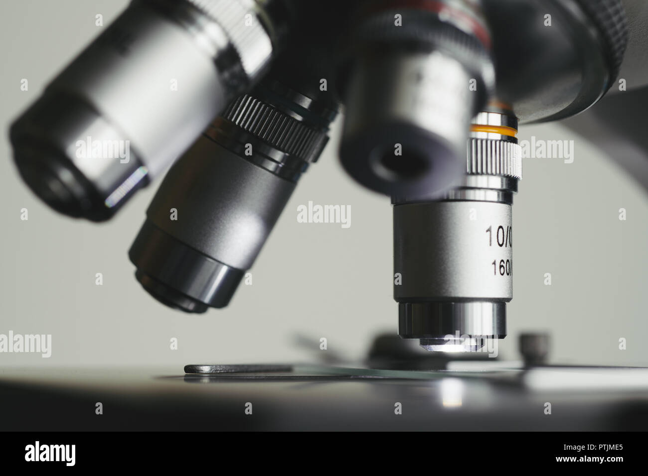 Modern microscope with metal lens at laboratory Stock Photo - Alamy