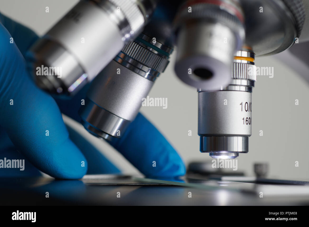 Scientist hands with microscope Stock Photo - Alamy