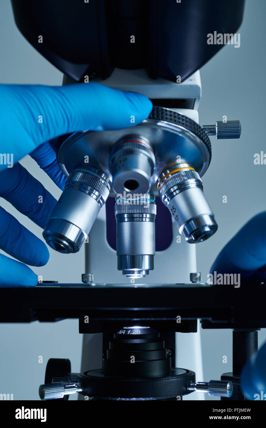 Scientist hands with microscope Stock Photo - Alamy