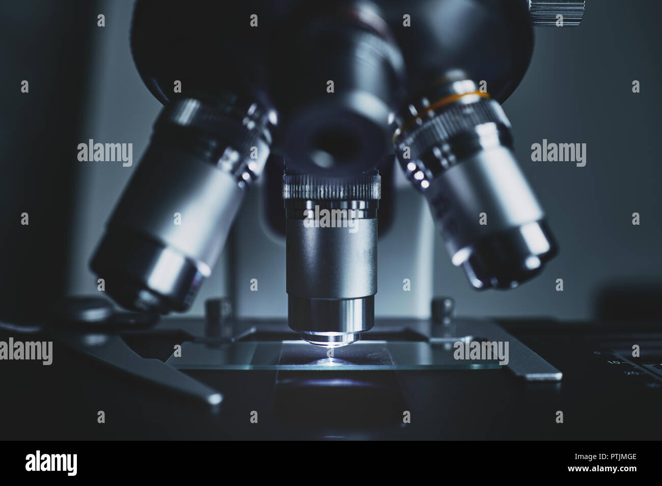 Modern microscope with metal lens at laboratory Stock Photo - Alamy