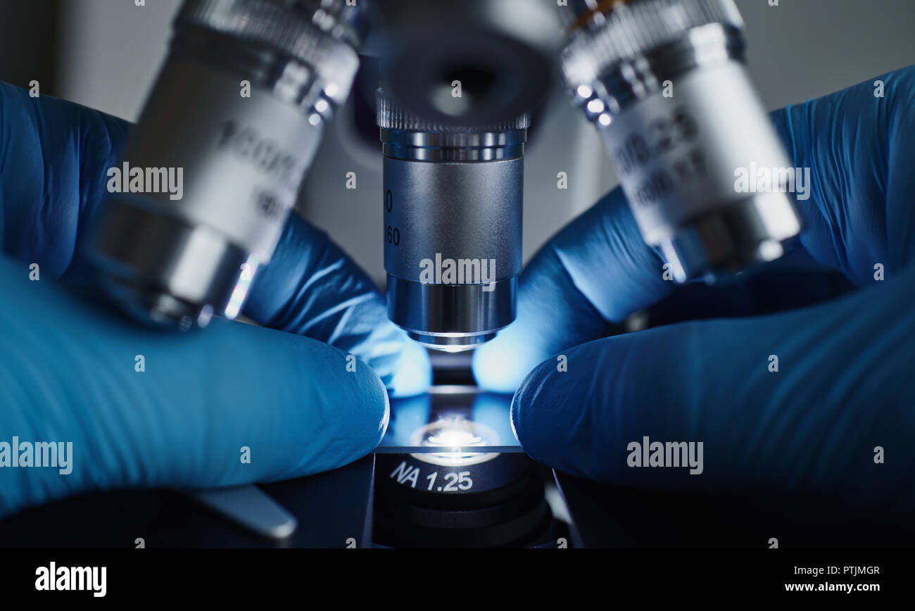 Scientist hands with microscope Stock Photo - Alamy