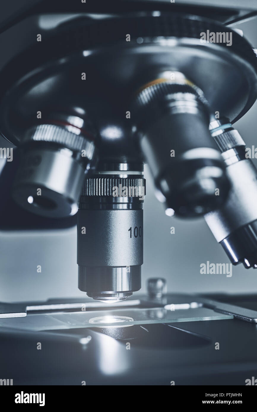 Modern microscope with metal lens at laboratory Stock Photo - Alamy