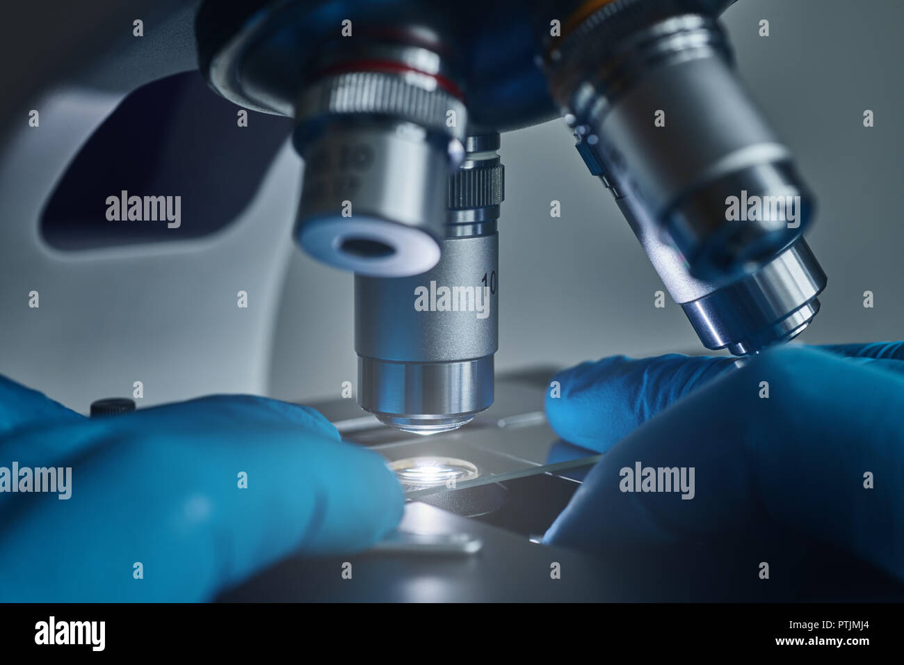 Scientist hands with microscope Stock Photo - Alamy