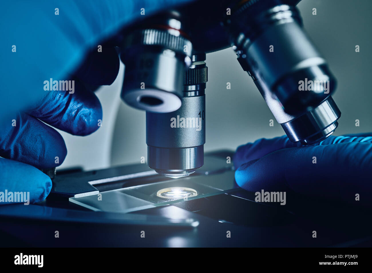 Scientist hands with microscope Stock Photo - Alamy