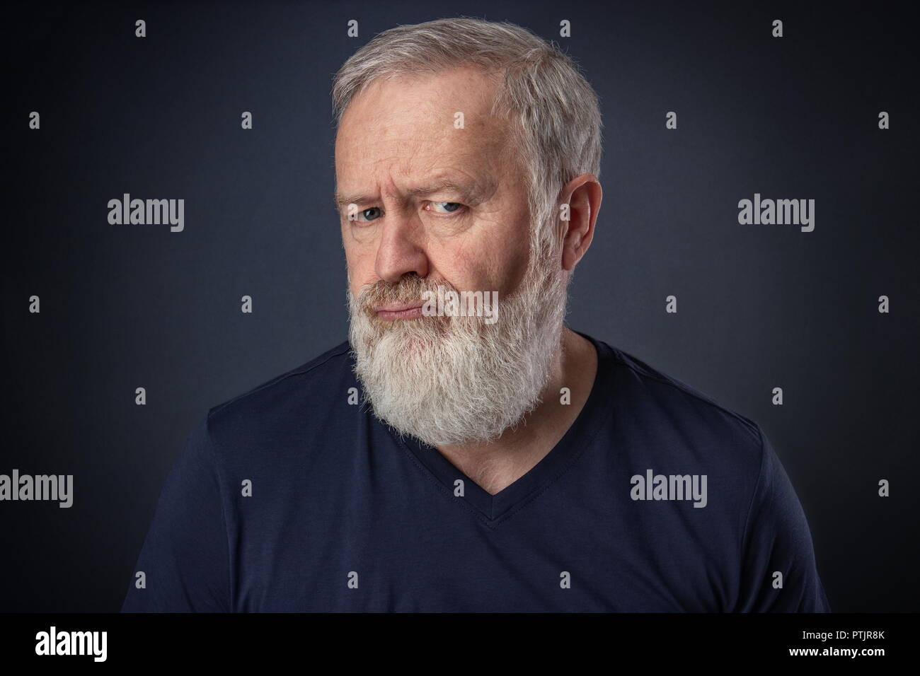Senior portrait with beard with a mocking and angry mimic Stock Photo ...