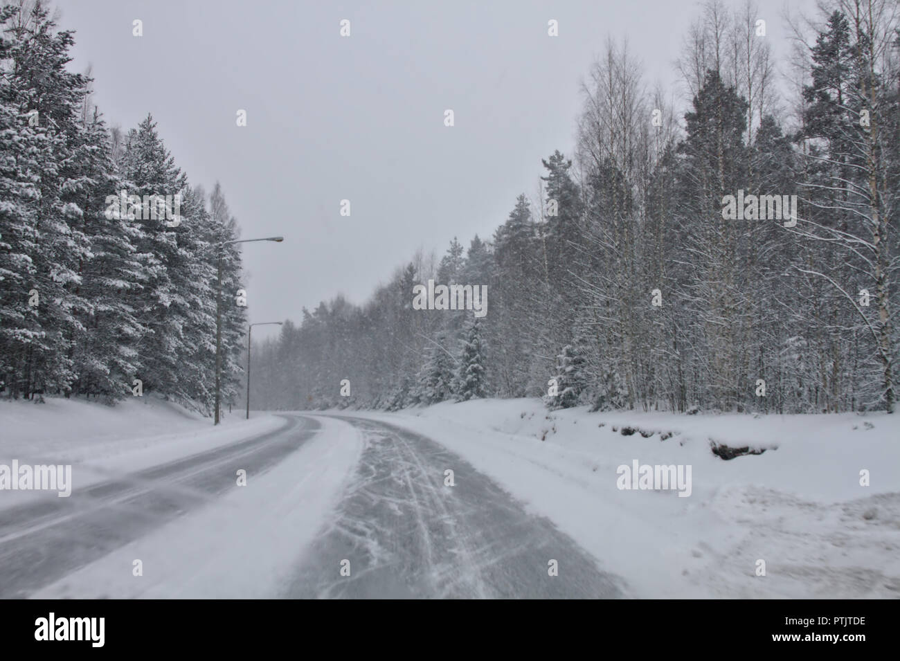 Iced and dangerous roads in the north in wintertime. Snow covering the ...