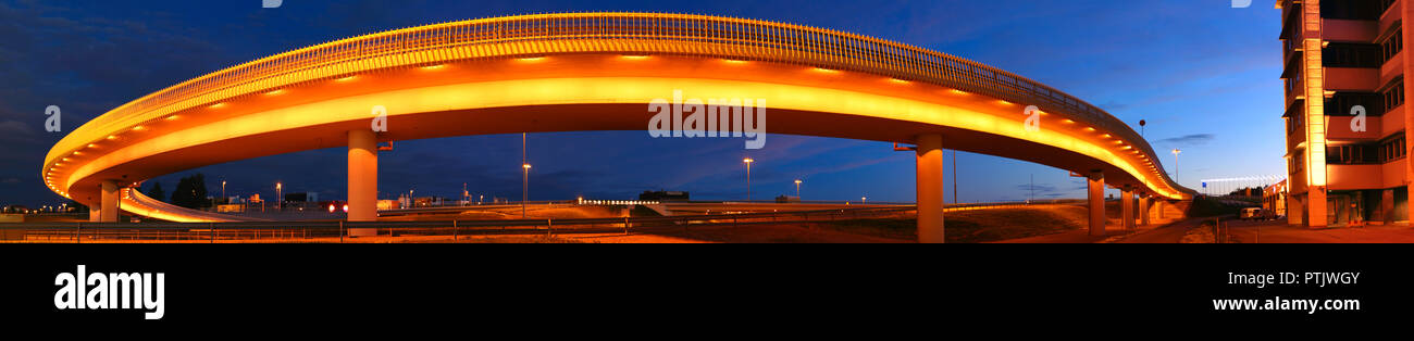 Night photo of a long round lighted bridge. Bridge surrounded with ...