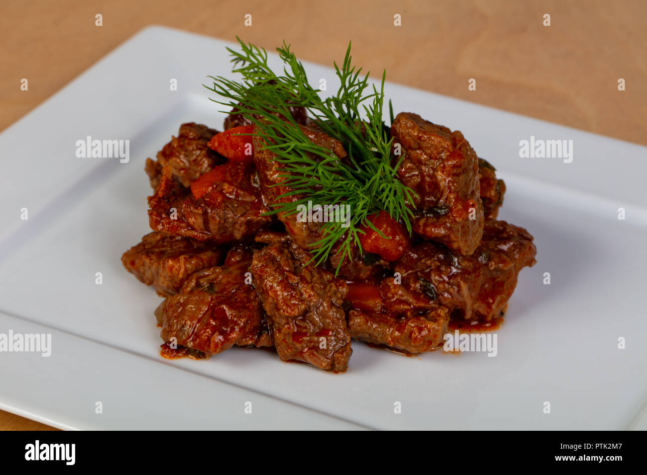 Beef goulash with tomato served dill Stock Photo - Alamy