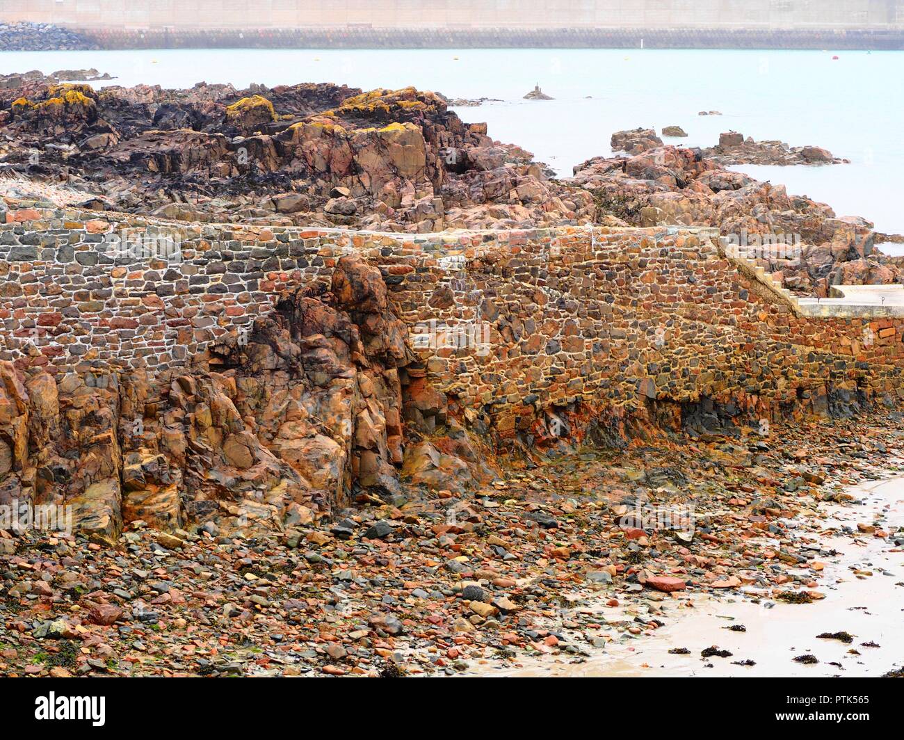Old sea wall showing coloured bricks Stock Photo - Alamy