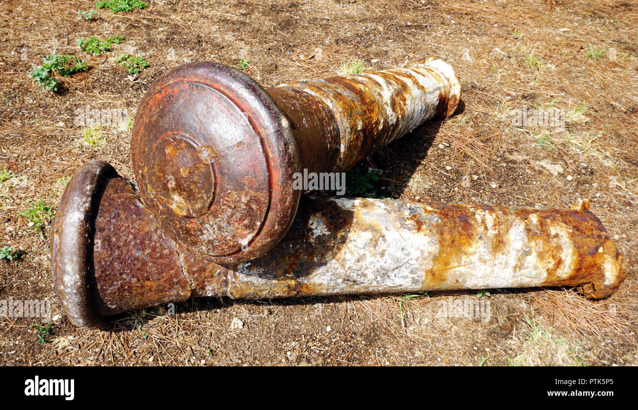 Two rusty old dock bollard on the ground Stock Photo - Alamy