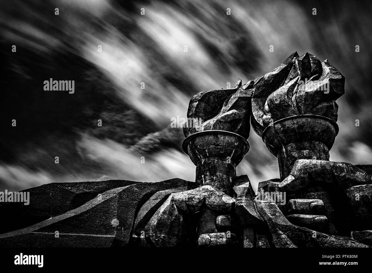 Large stone hands hold torches to greet visitors to the Buzludzha ...