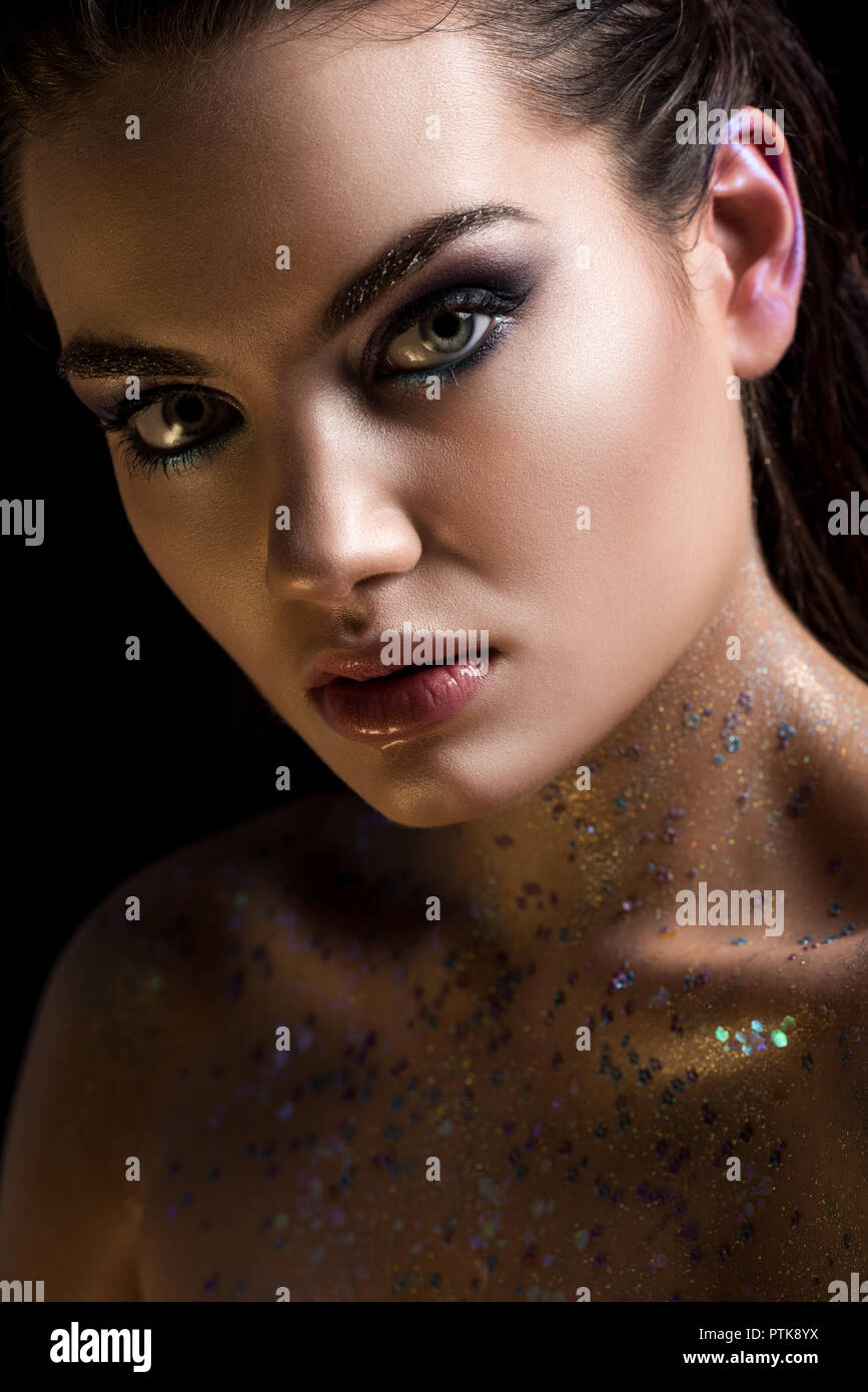 glamorous model posing with glitter on body for fashion shoot, isolated ...