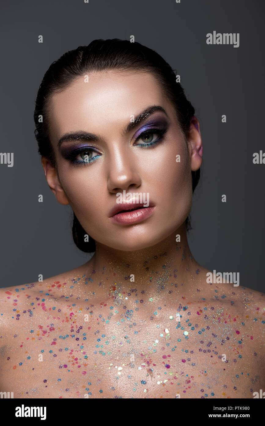 glamorous girl with glitter and sparkles on body, isolated on grey ...