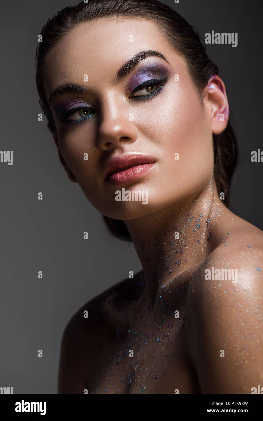 glamorous girl posing with glitter on body for fashion shoot, isolated ...
