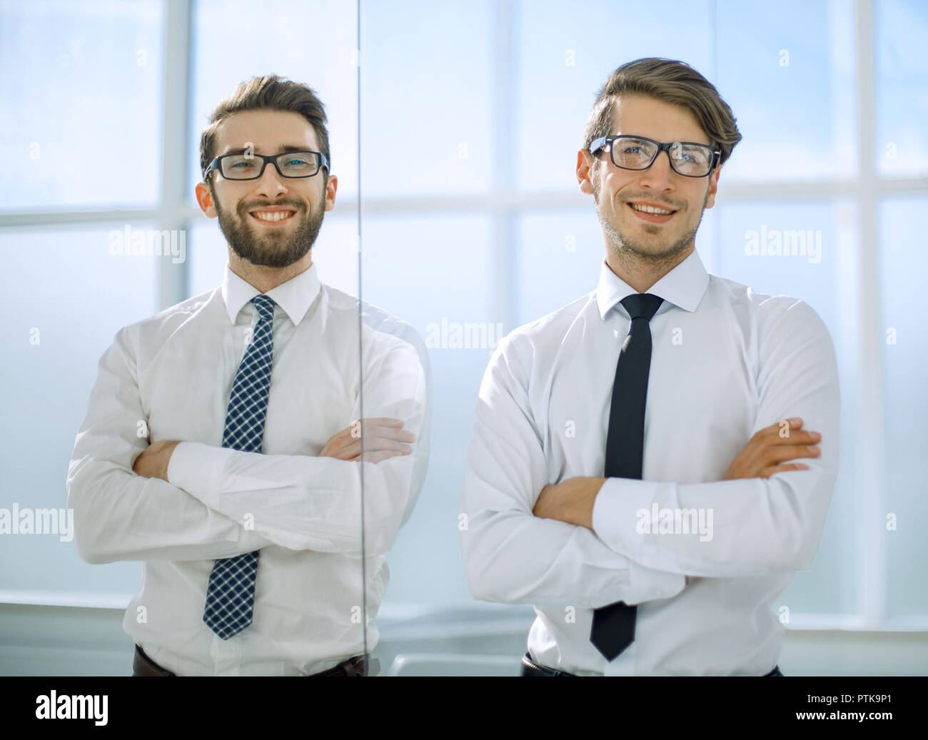 two serious business people standing in the office Stock Photo - Alamy