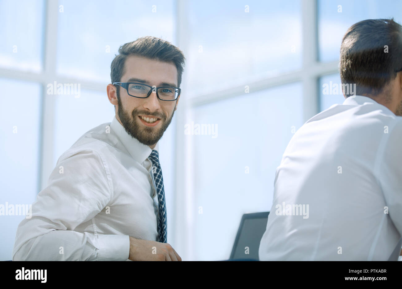 rear view.successful employee looking at the camera Stock Photo - Alamy