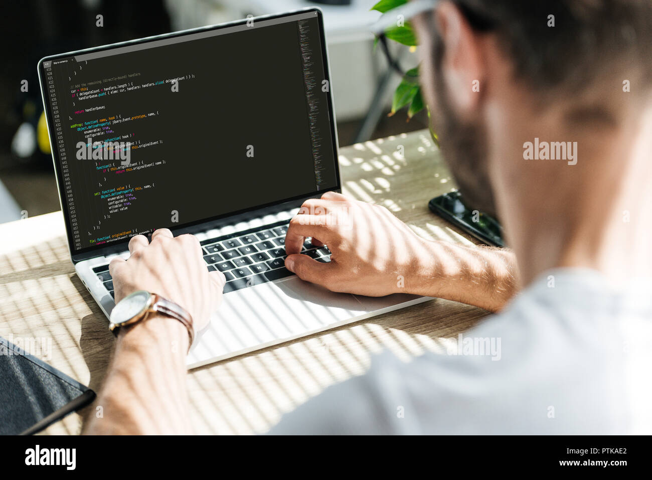 back view of man using laptop with html code on screen Stock Photo - Alamy