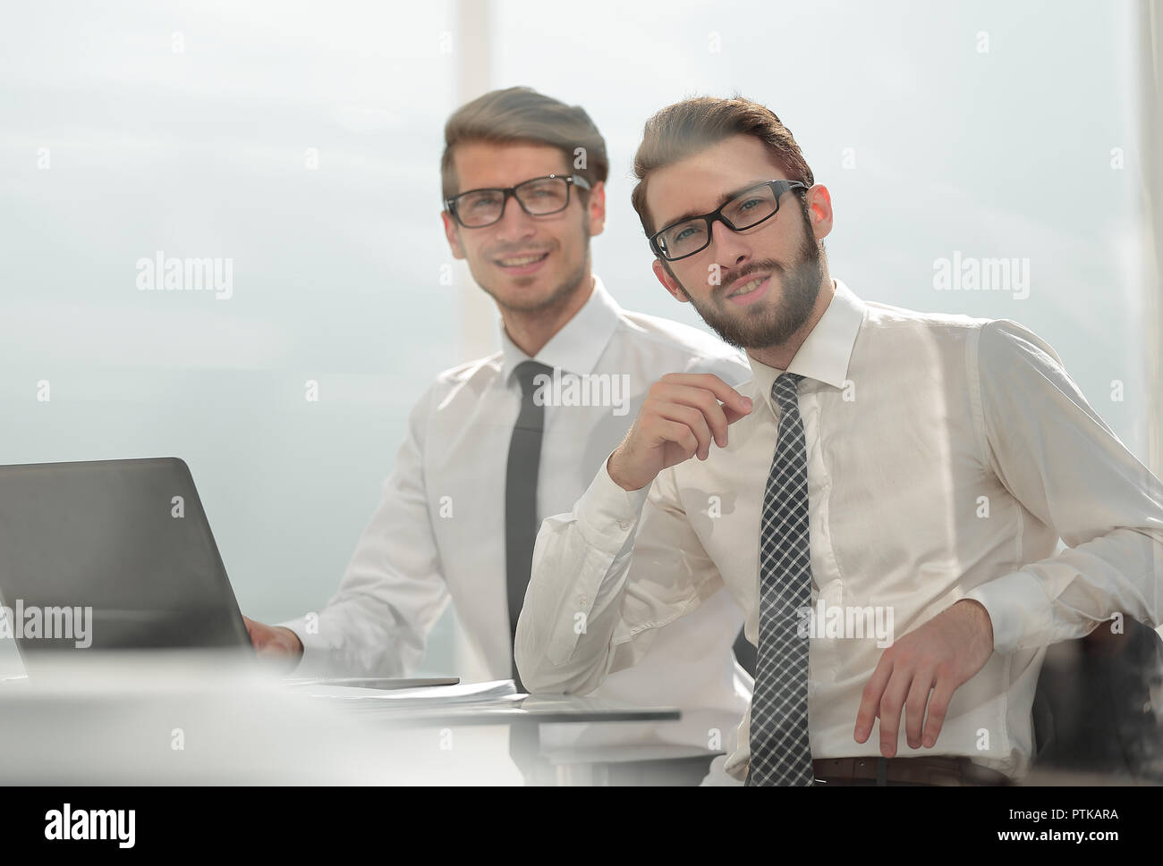two business people sitting at the office Desk Stock Photo - Alamy