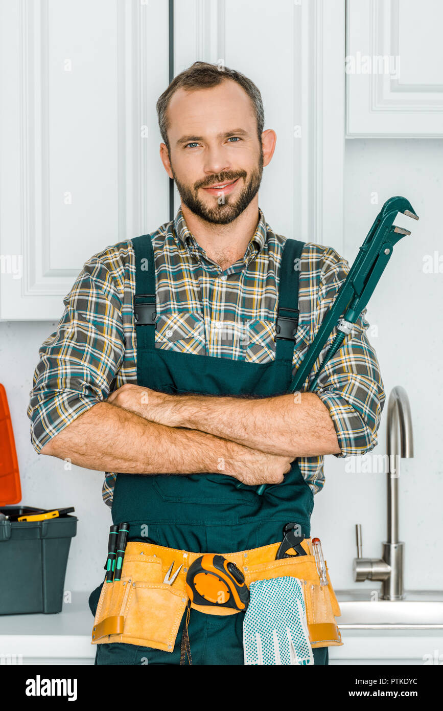 Handsome smiling plumber at the kitchen hi-res stock photography and ...