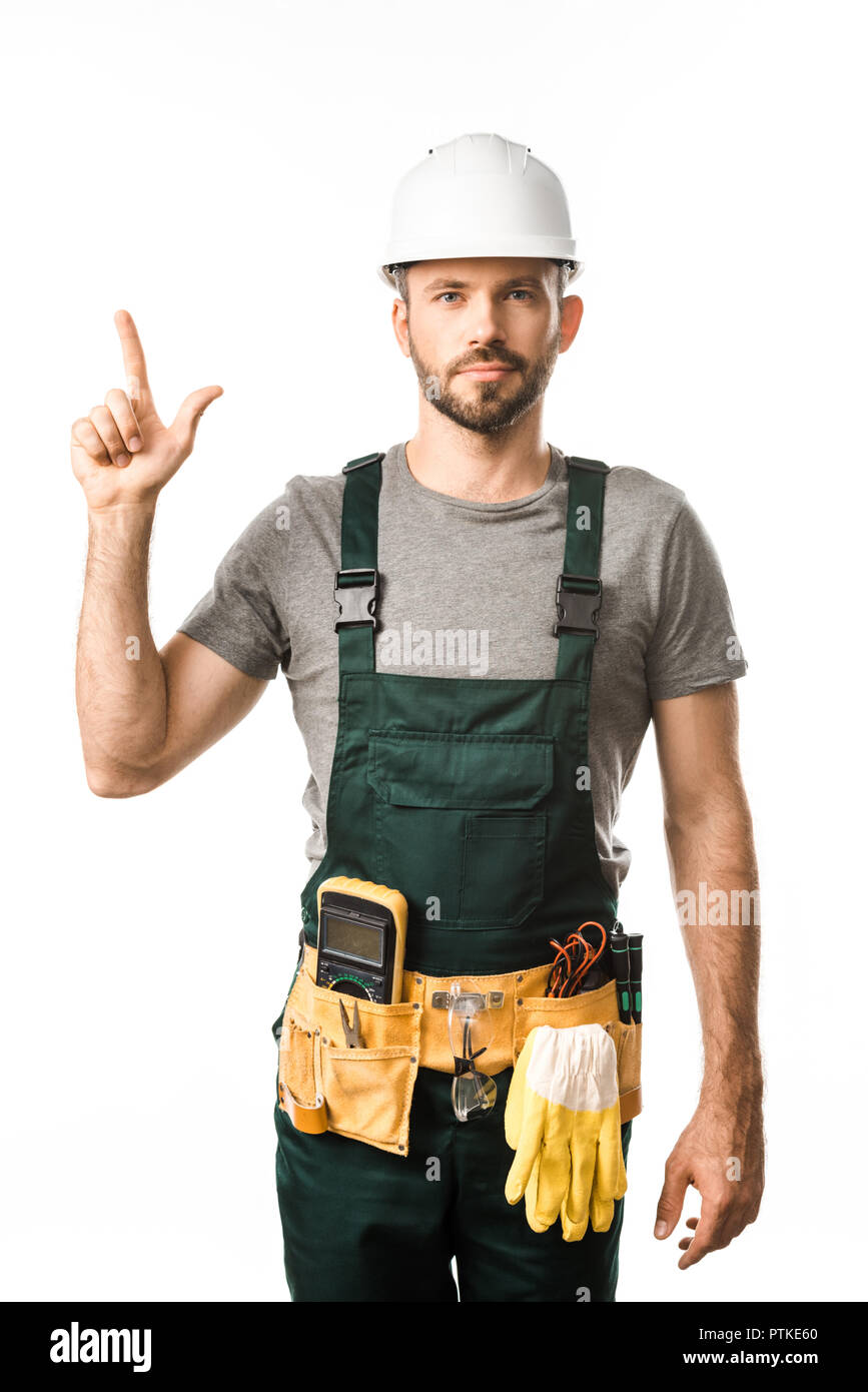 handsome electrician with tool belt pointing up isolated on white Stock ...