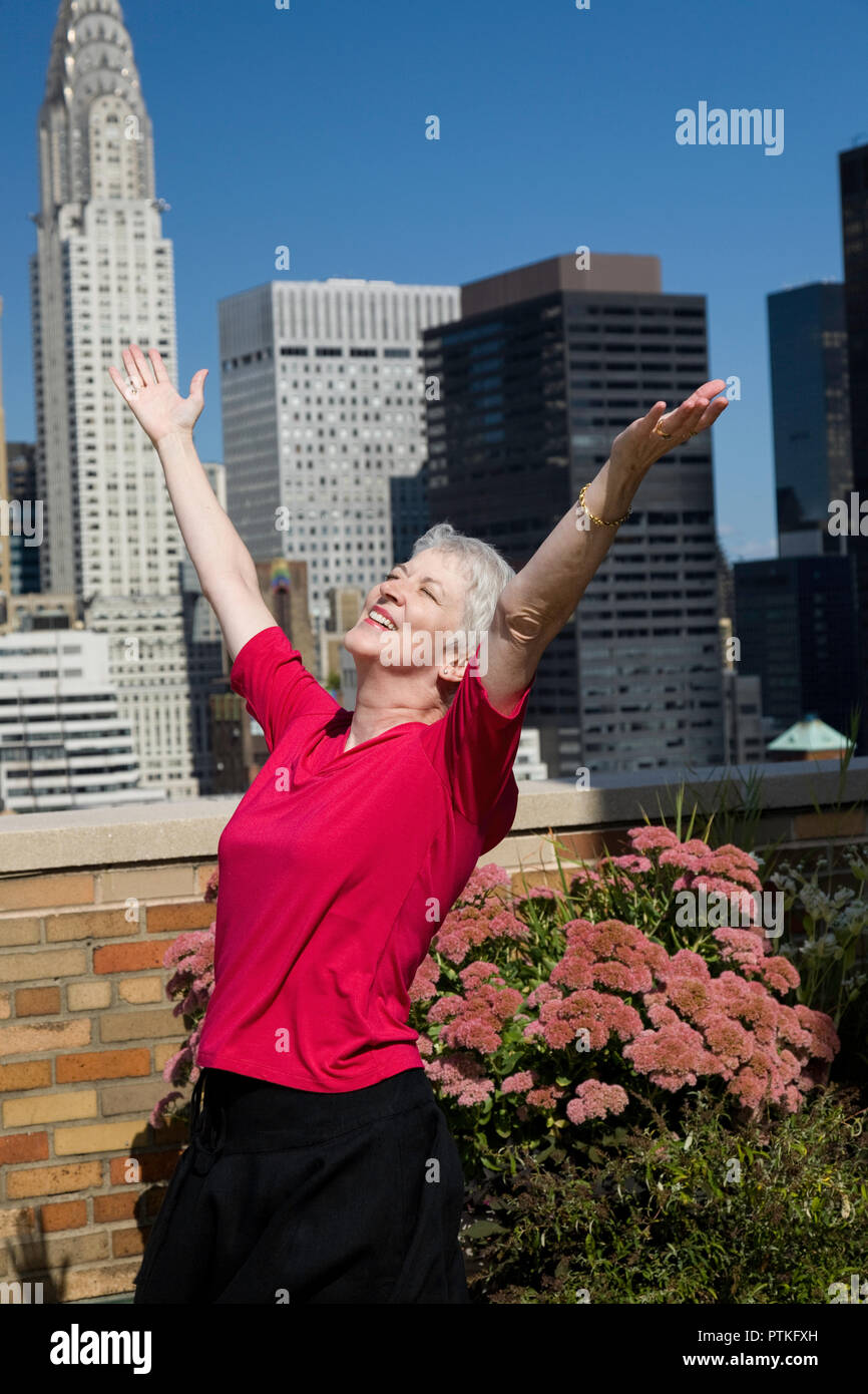 Energetic mature woman seizing the day in New York City, USA Stock ...