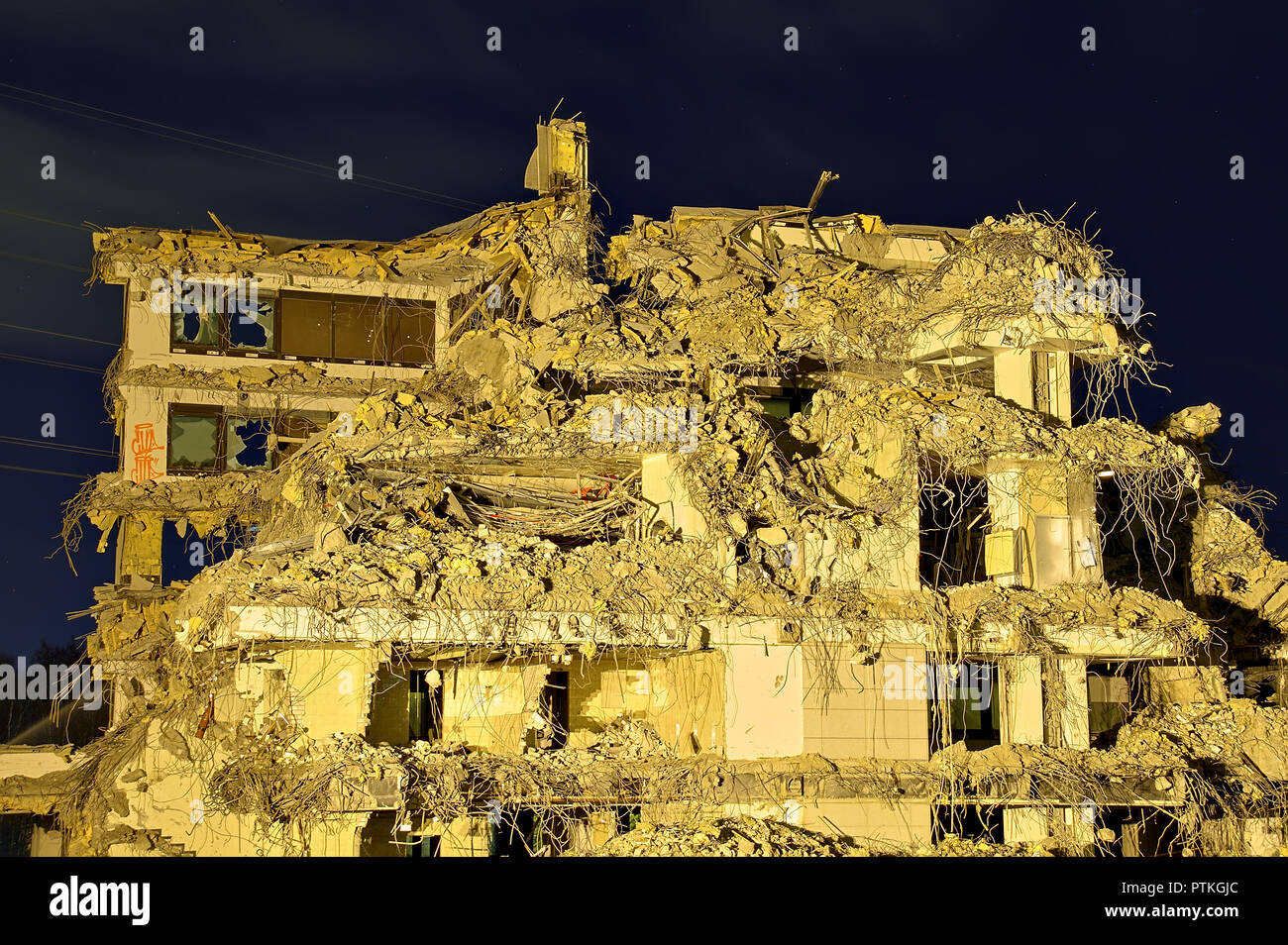 Collapsed large office building with interior rooms visible. Only rear ...