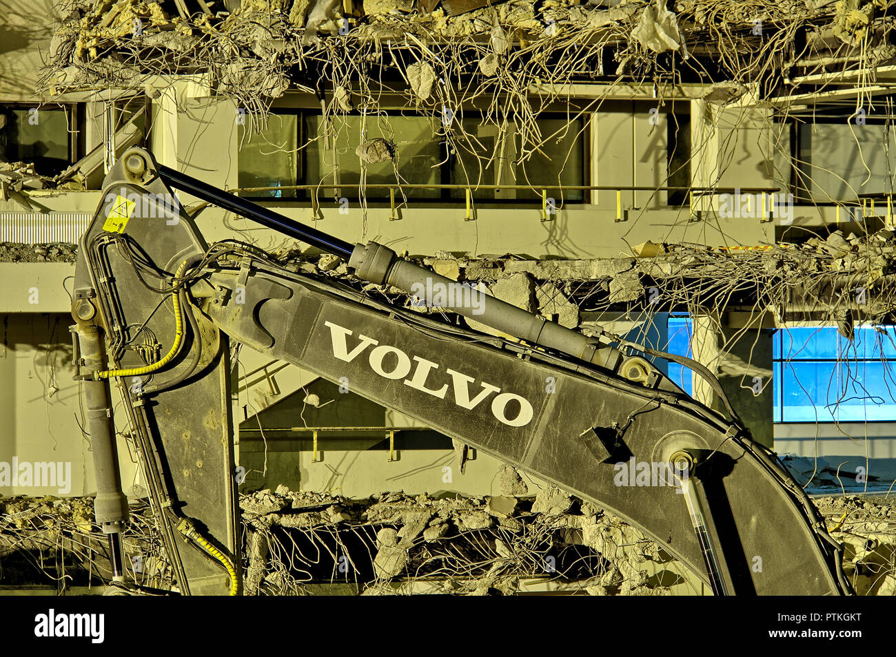 Volvo excavator on demolition site at night. Photo taken at demolition ...