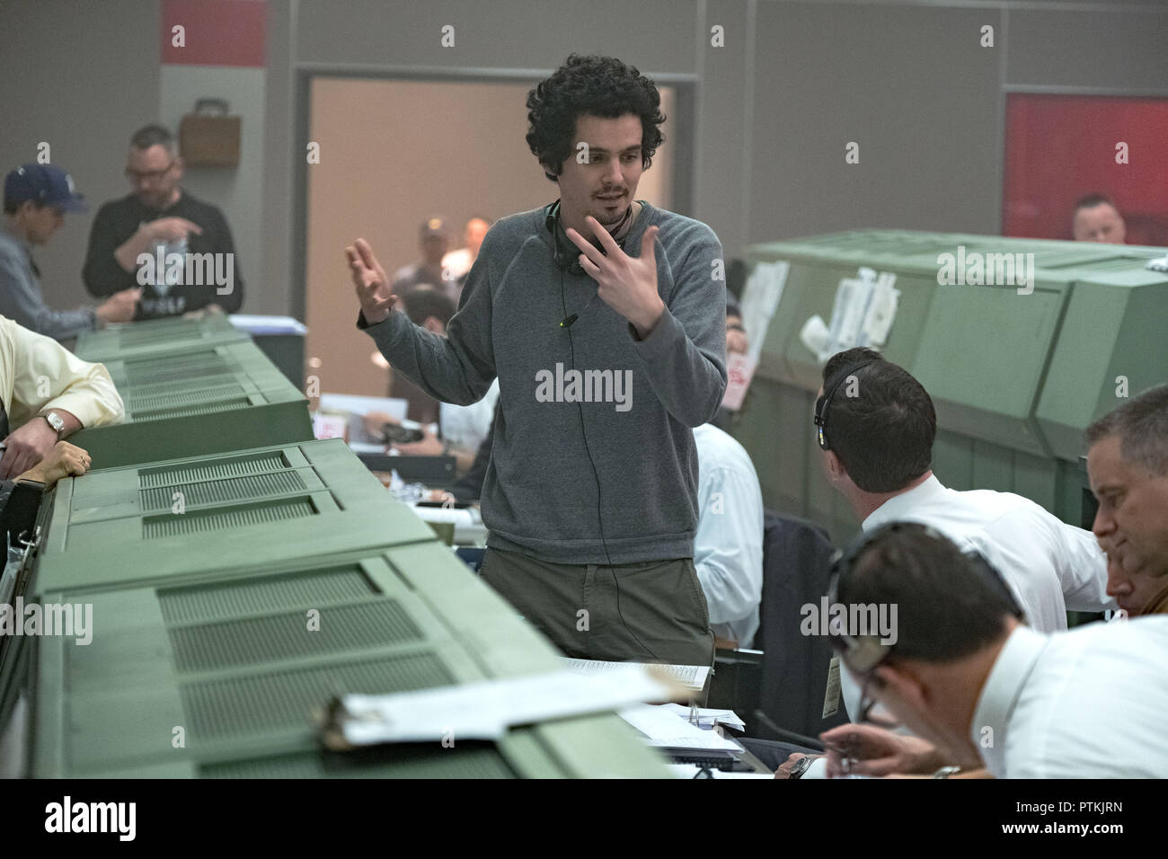 FIRST MAN, (standing) director Damien Chazelle, on-set, 2018. ph ...