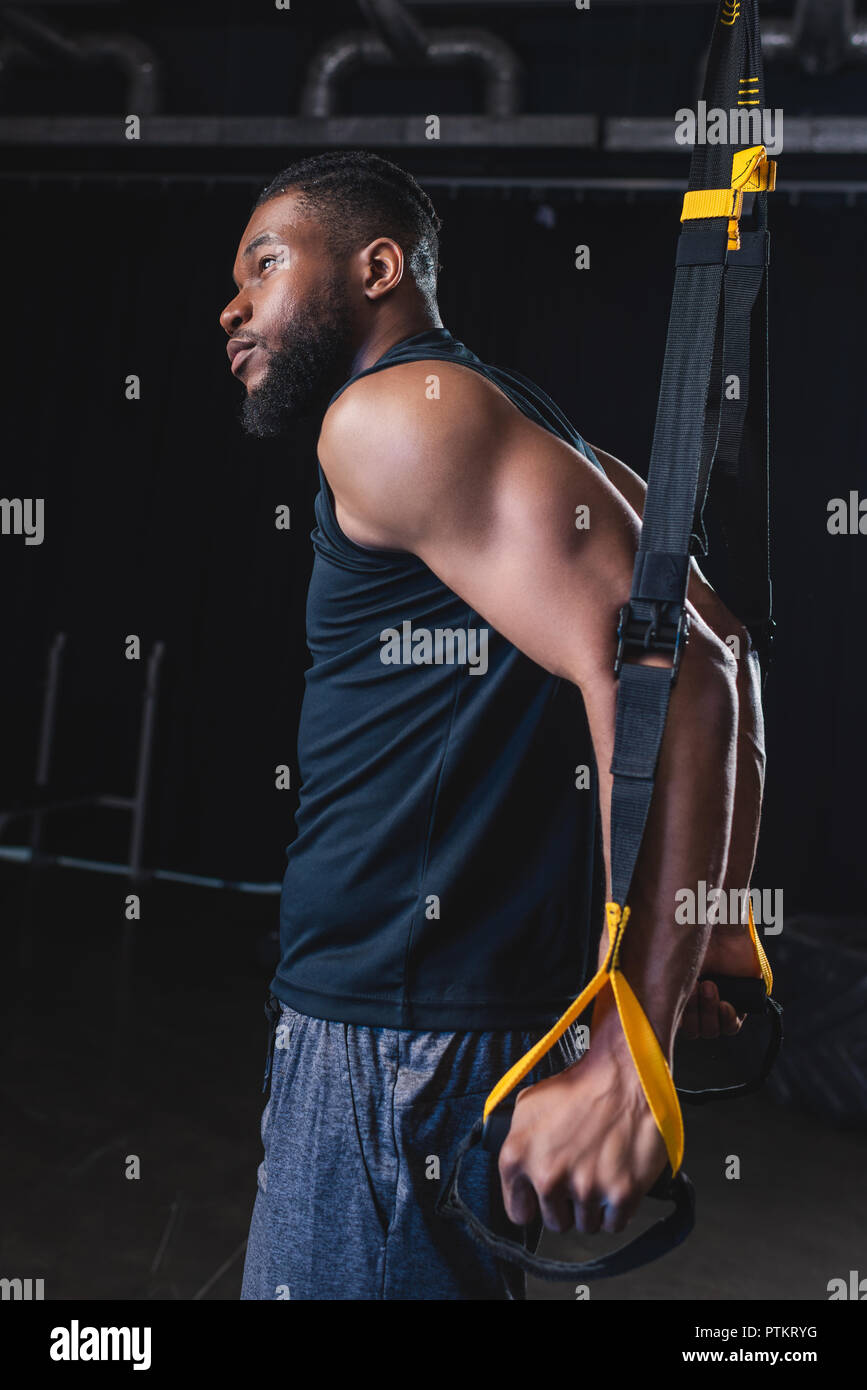 side view of muscular african american man looking away while training ...