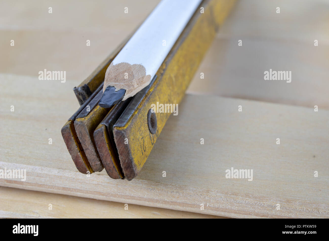 Carpenter's measure and pencil on a workshop table. Measurement of ...