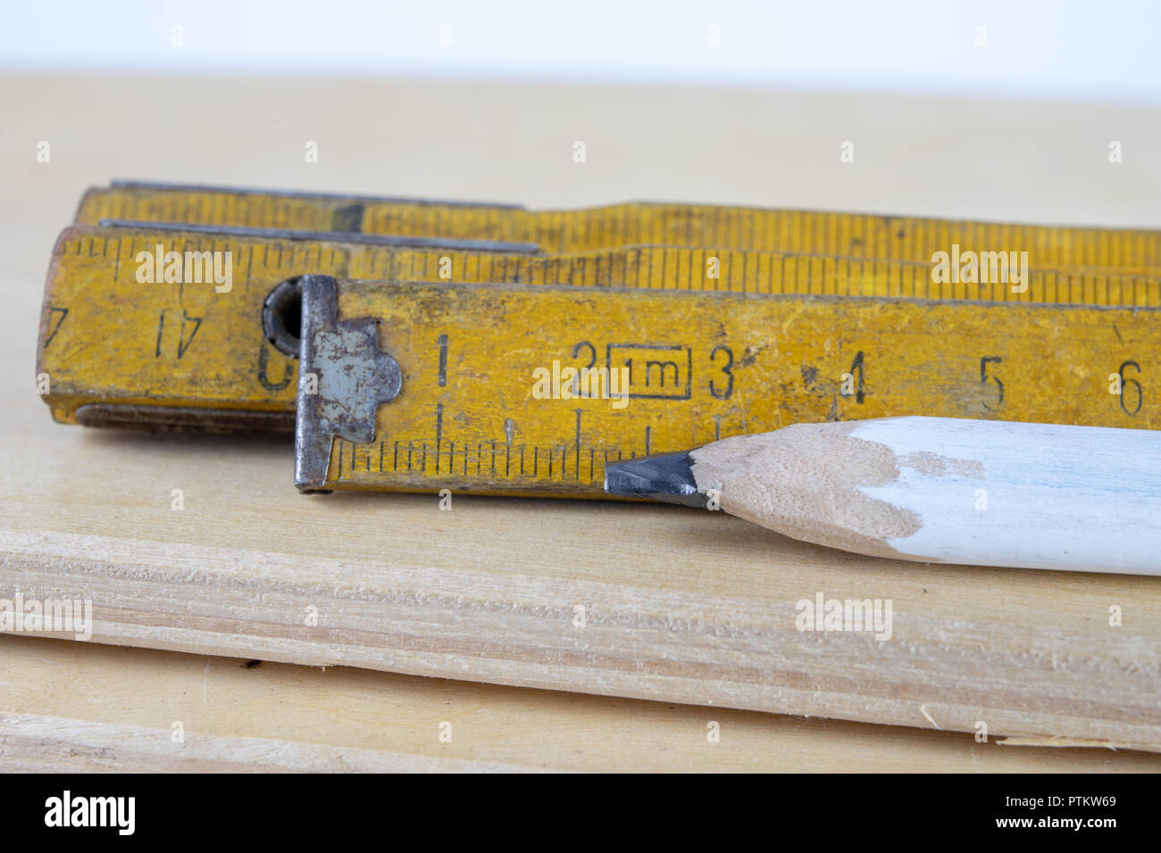 Carpenter's measure and pencil on a workshop table. Measurement of ...