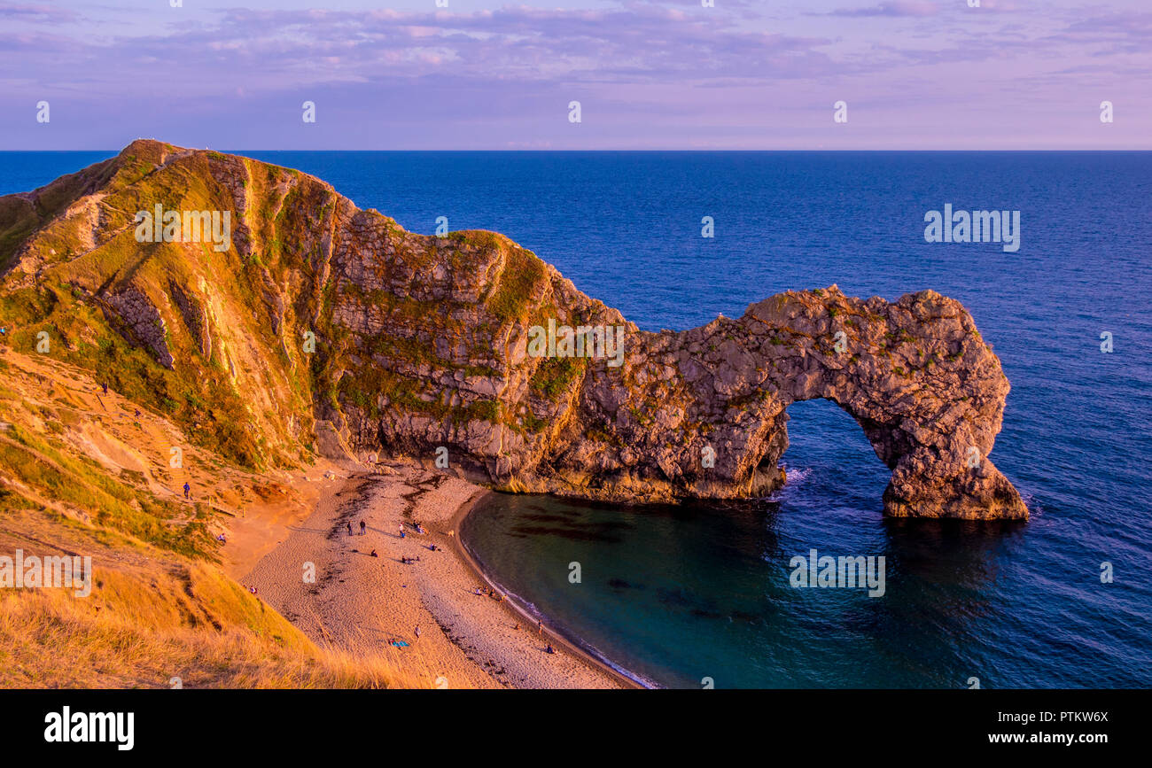 Sunset over Durdle Door - the most famous landmark in Devon England ...
