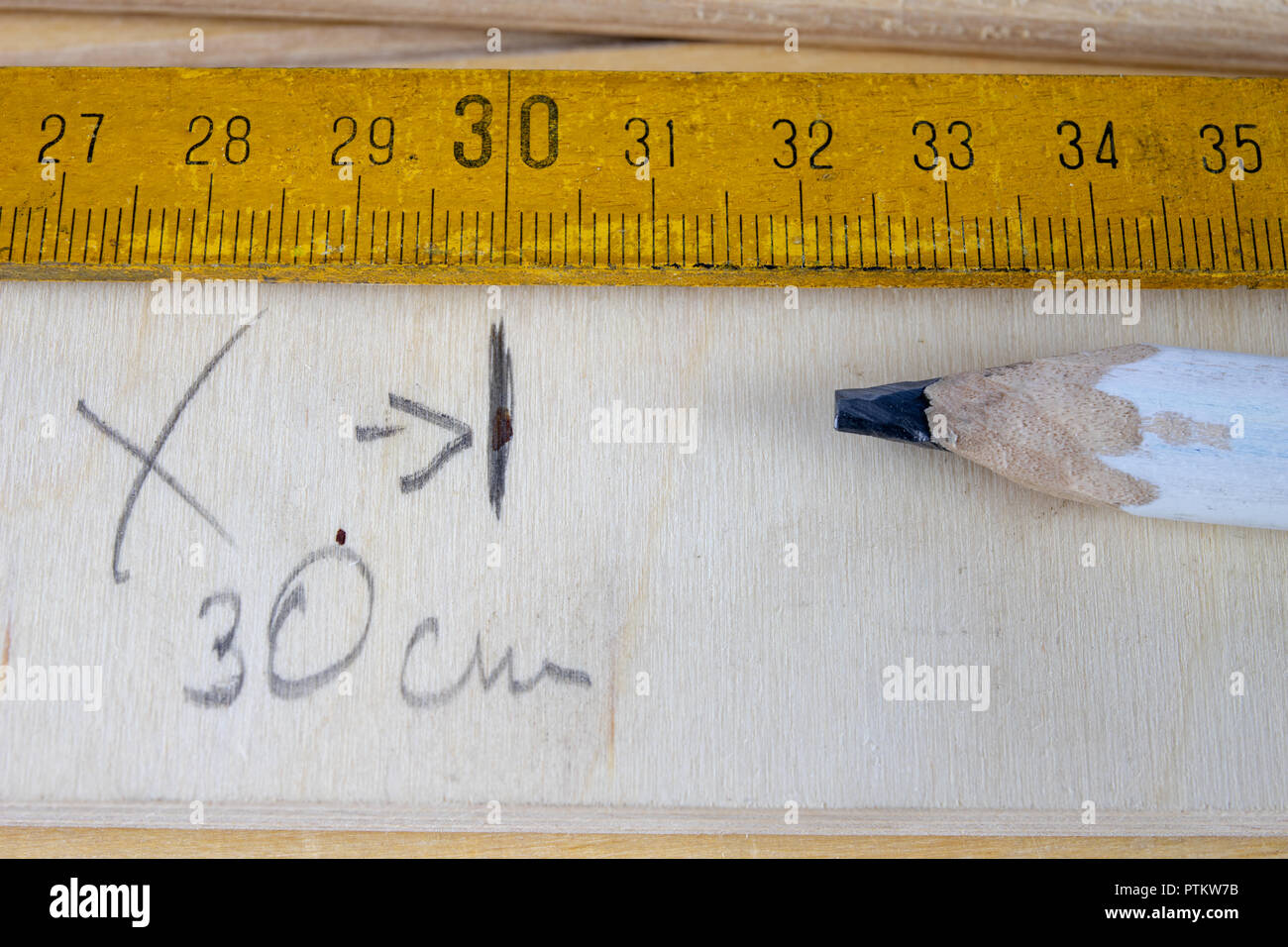 Carpenter's measure and pencil on a workshop table. Measurement of ...