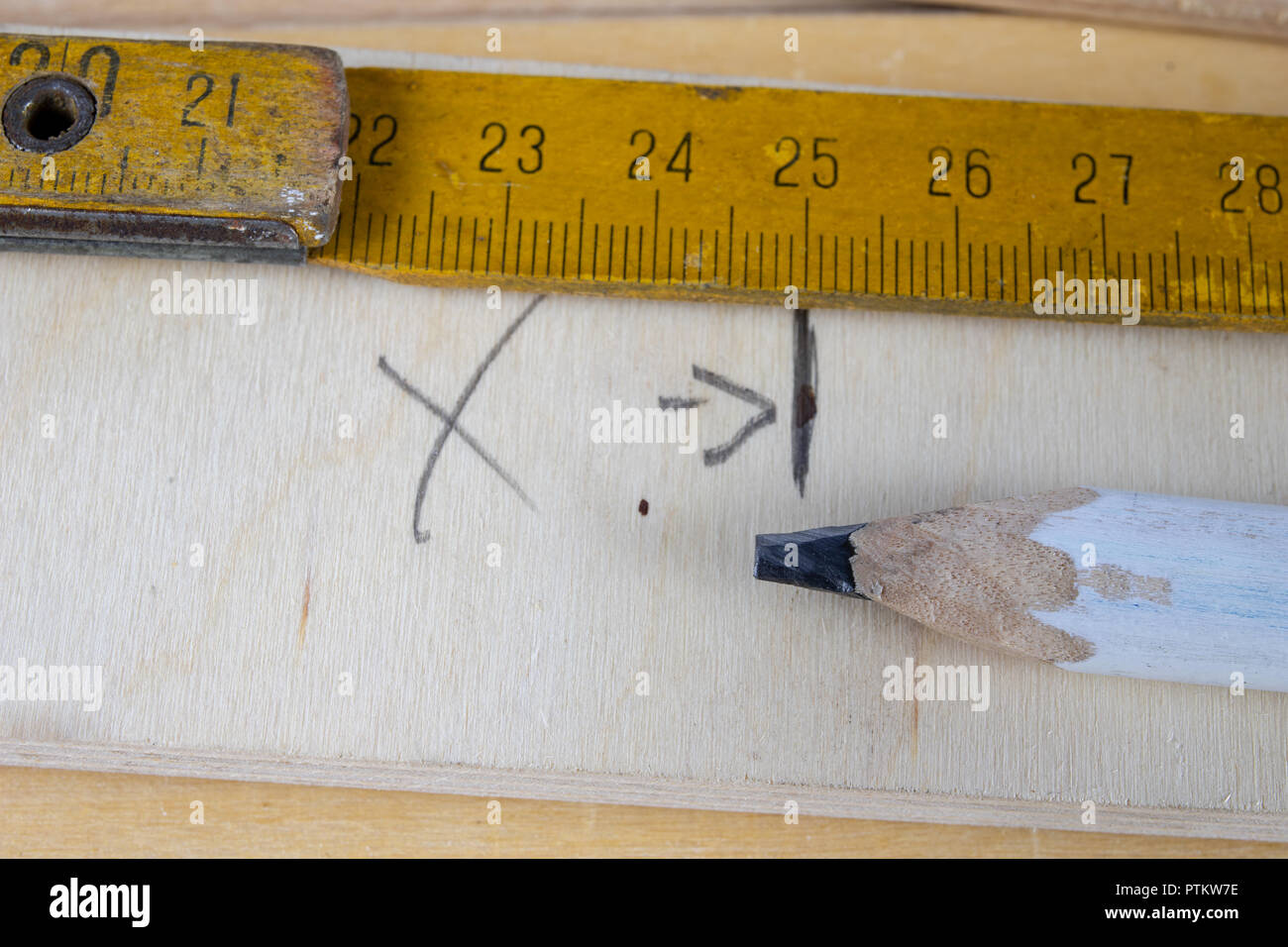 Carpenter's measure and pencil on a workshop table. Measurement of ...