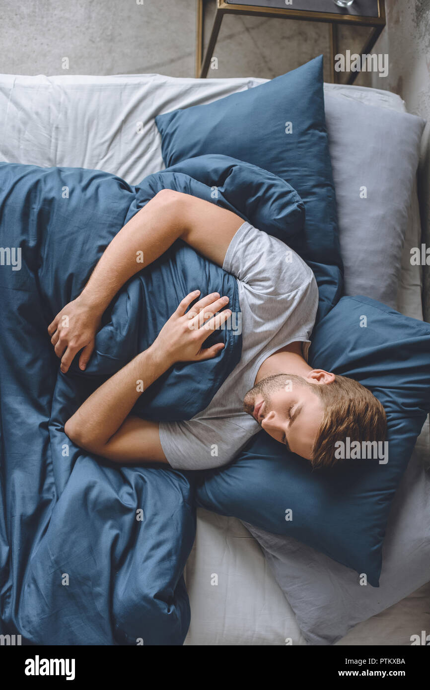 Man sleeping in bed overhead hi-res stock photography and images - Alamy
