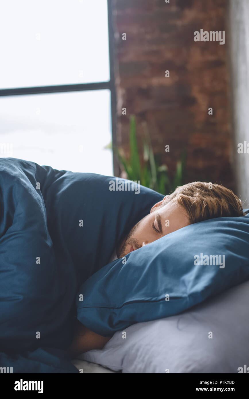 Sleeping man under bed hi-res stock photography and images - Alamy