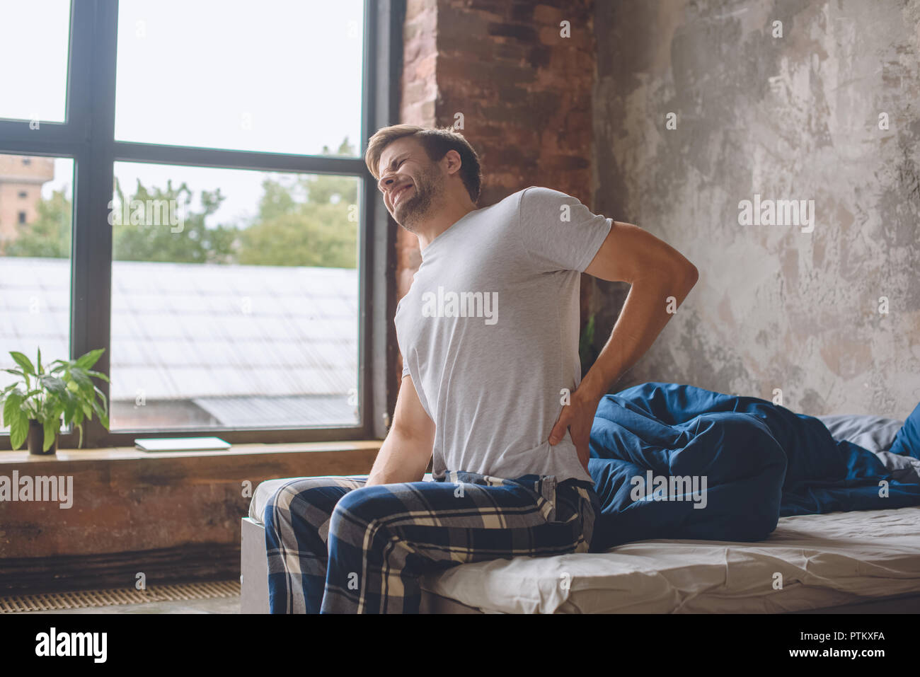 Man sitting up in bed hi-res stock photography and images - Alamy