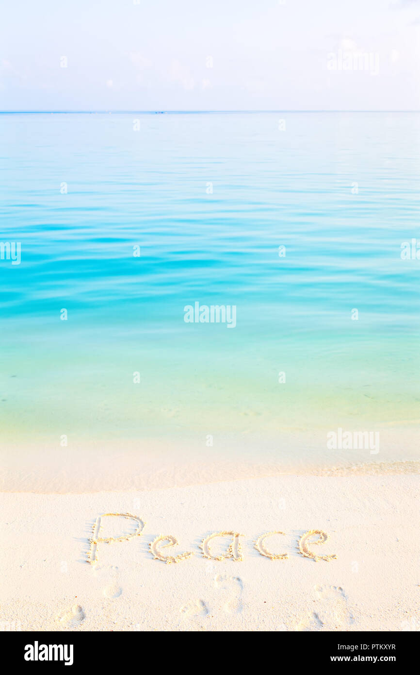 The Word Peace Written in the Sand on a Beach with morning sea ...