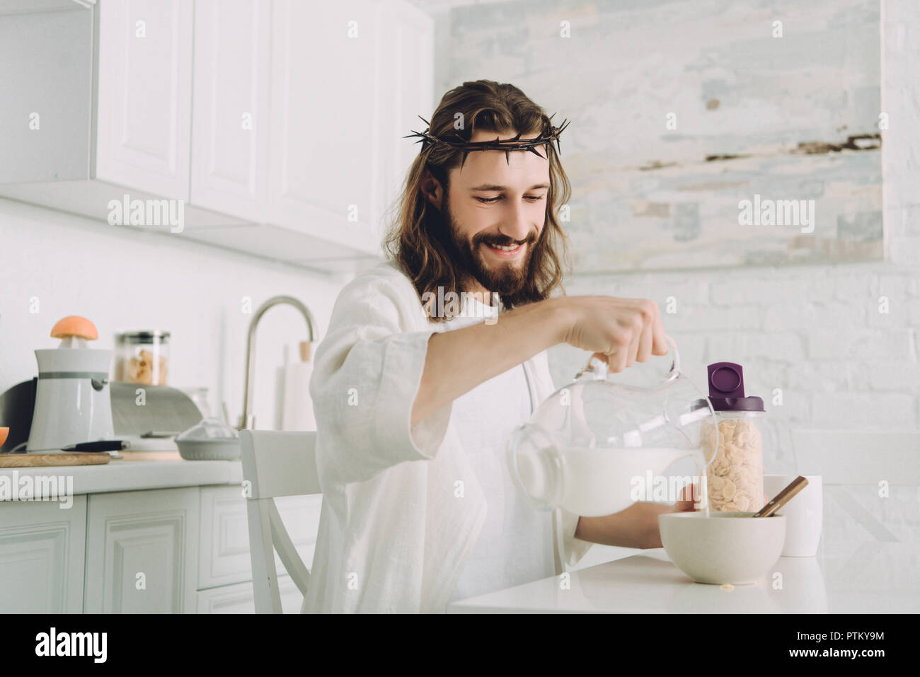 happy Jesus pouring milk into bowl with corn flakes on breakfast in ...