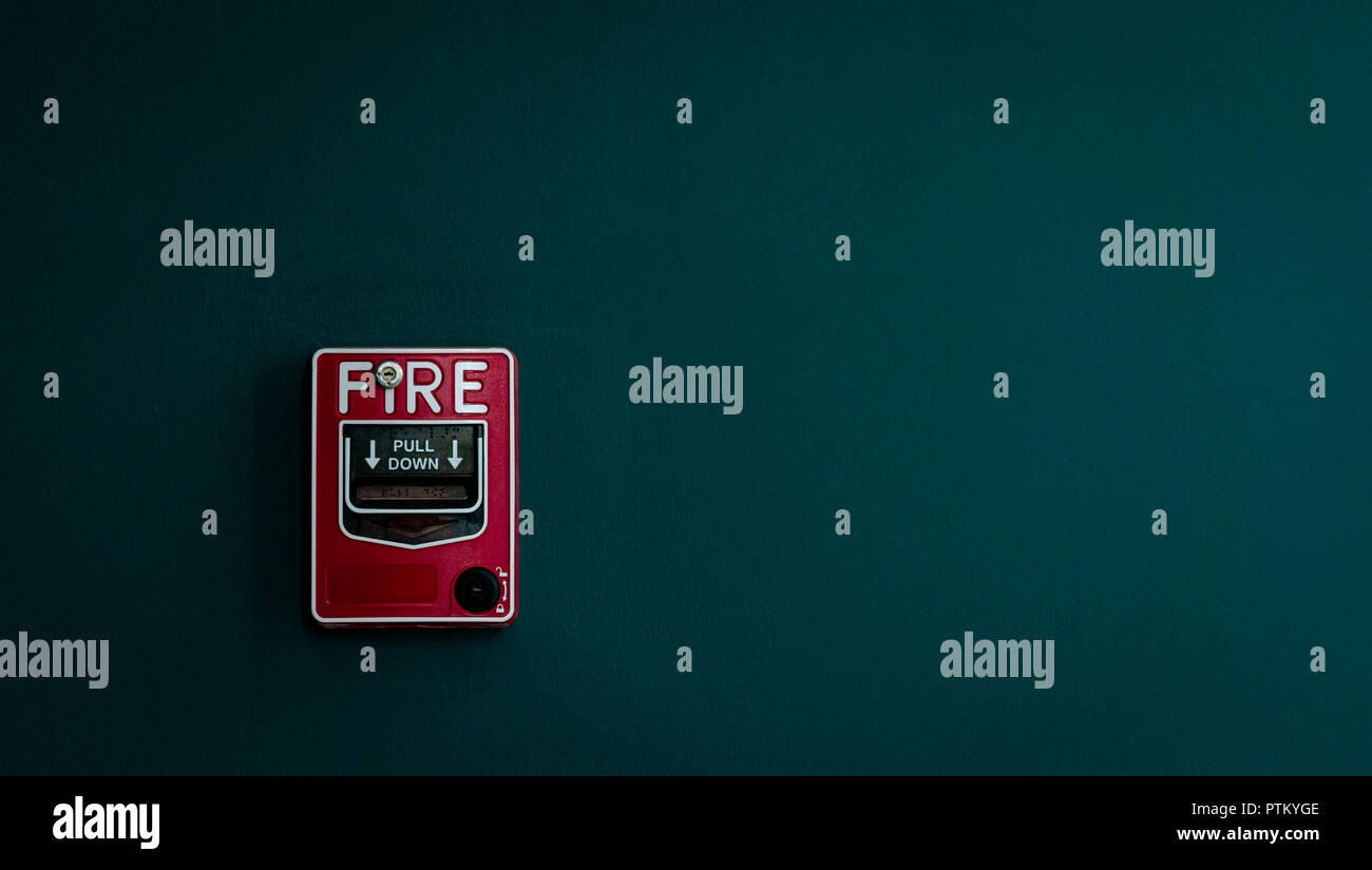 Fire alarm on dark green concrete wall. Warning and security system ...