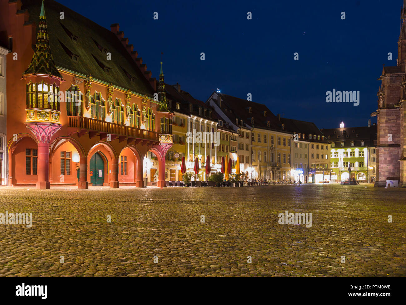 Illuminated historical market hall and Cathedral Square at night ...