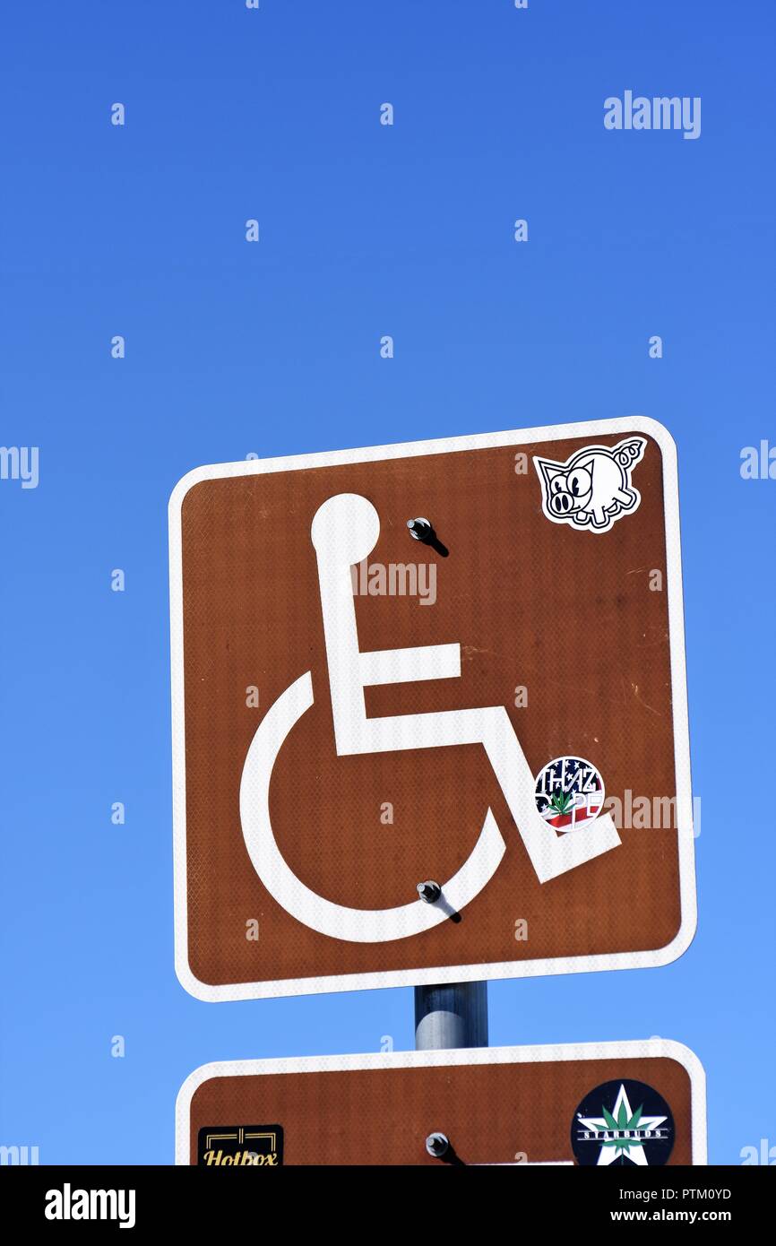 Defaced Street signs for handicapped and informational concepts with ...